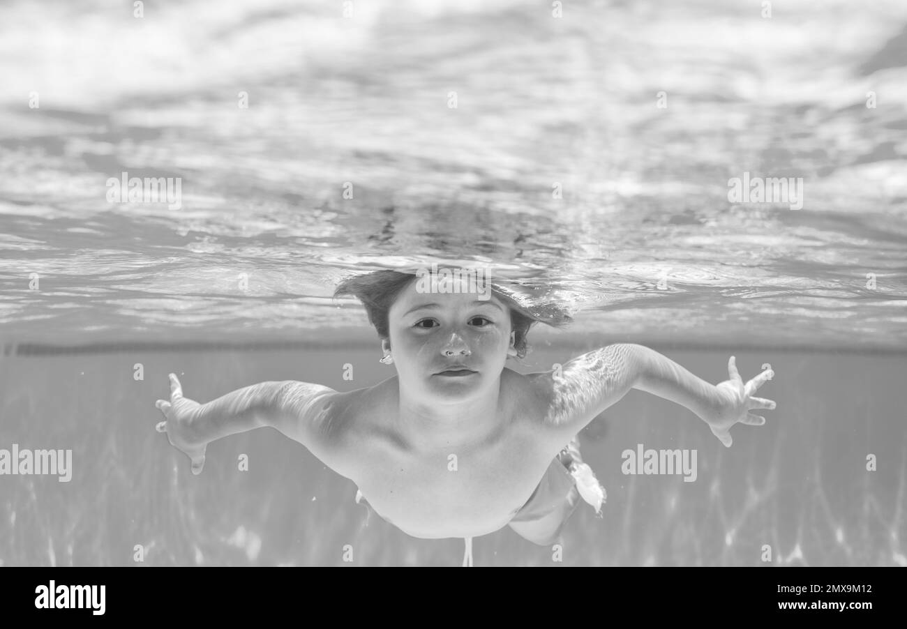 Underwater child in the swimming pool. Cute kid boy swimming in pool ... Underwater child in the swimming pool. Cute kid boy swimming in pool ...
