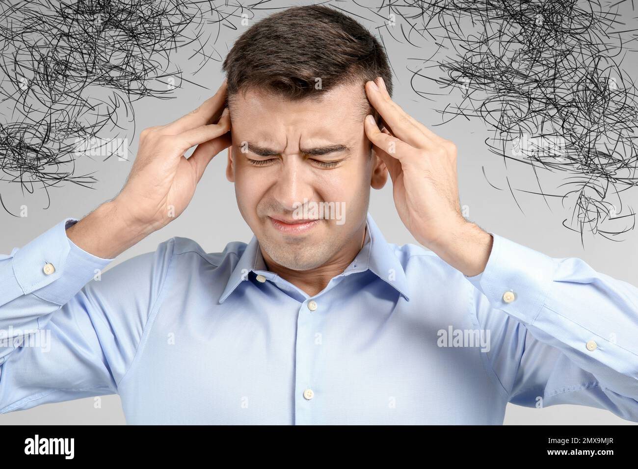 Stressed man with mess in his head on light background Stock Photo - Alamy