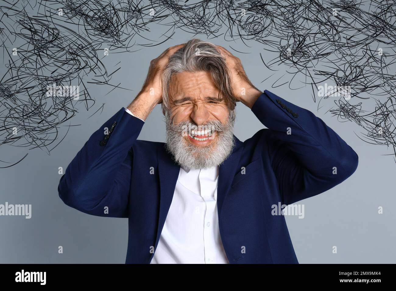 Stressed man with mess in his head on grey background Stock Photo - Alamy