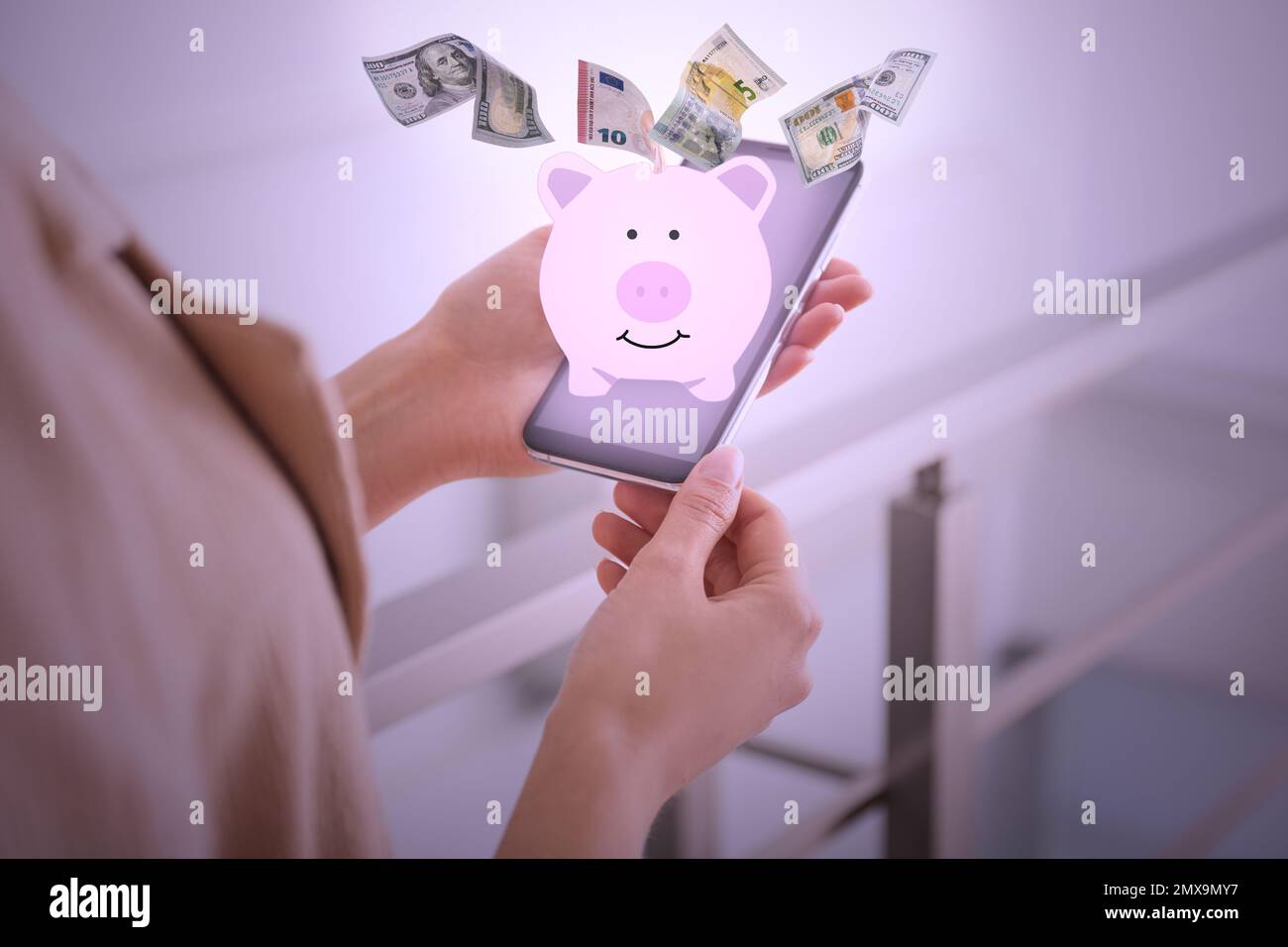 Woman using online bank application on her smartphone indoors Stock ...