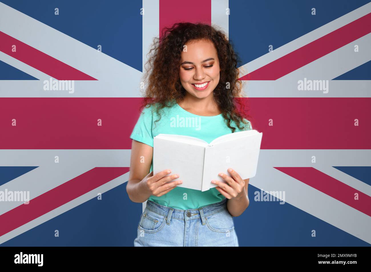 Beautiful African-American young girl reading book and flag of Great ...