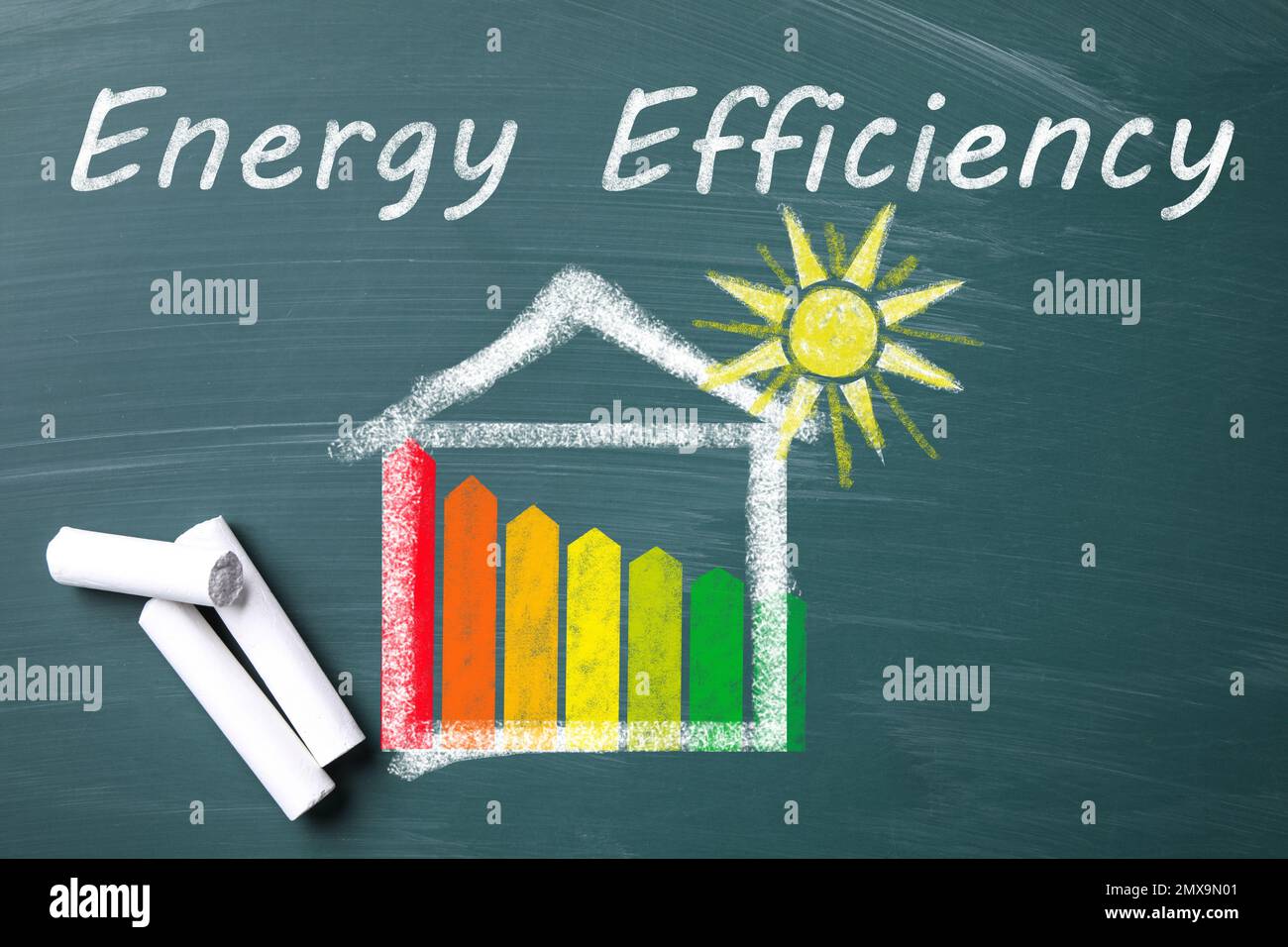 Energy efficiency concept. Pieces of chalk and house drawn on ...
