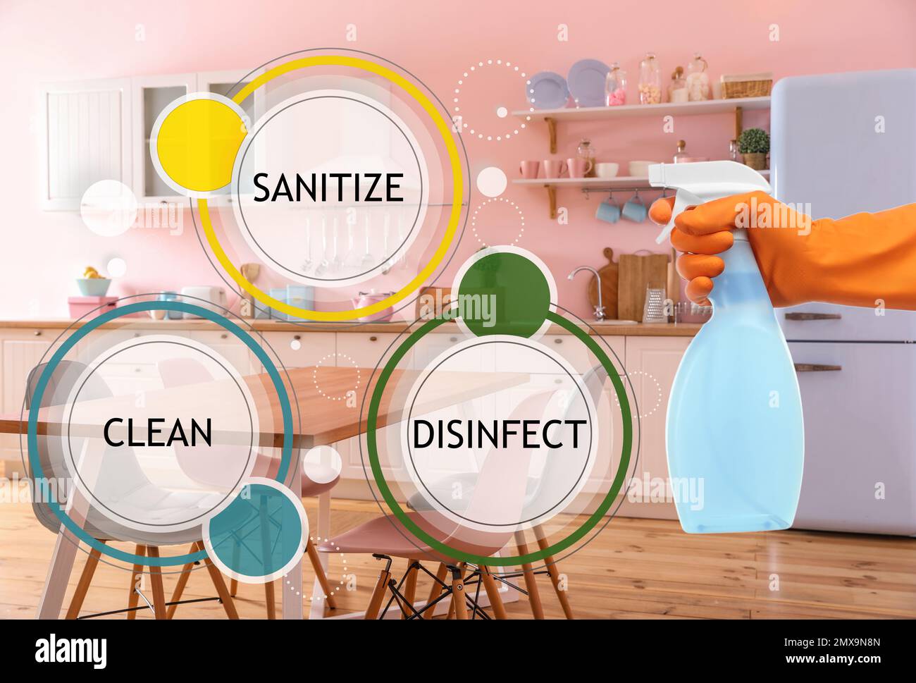 Keep your home virus-free. Woman cleaning kitchen with disinfecting ...