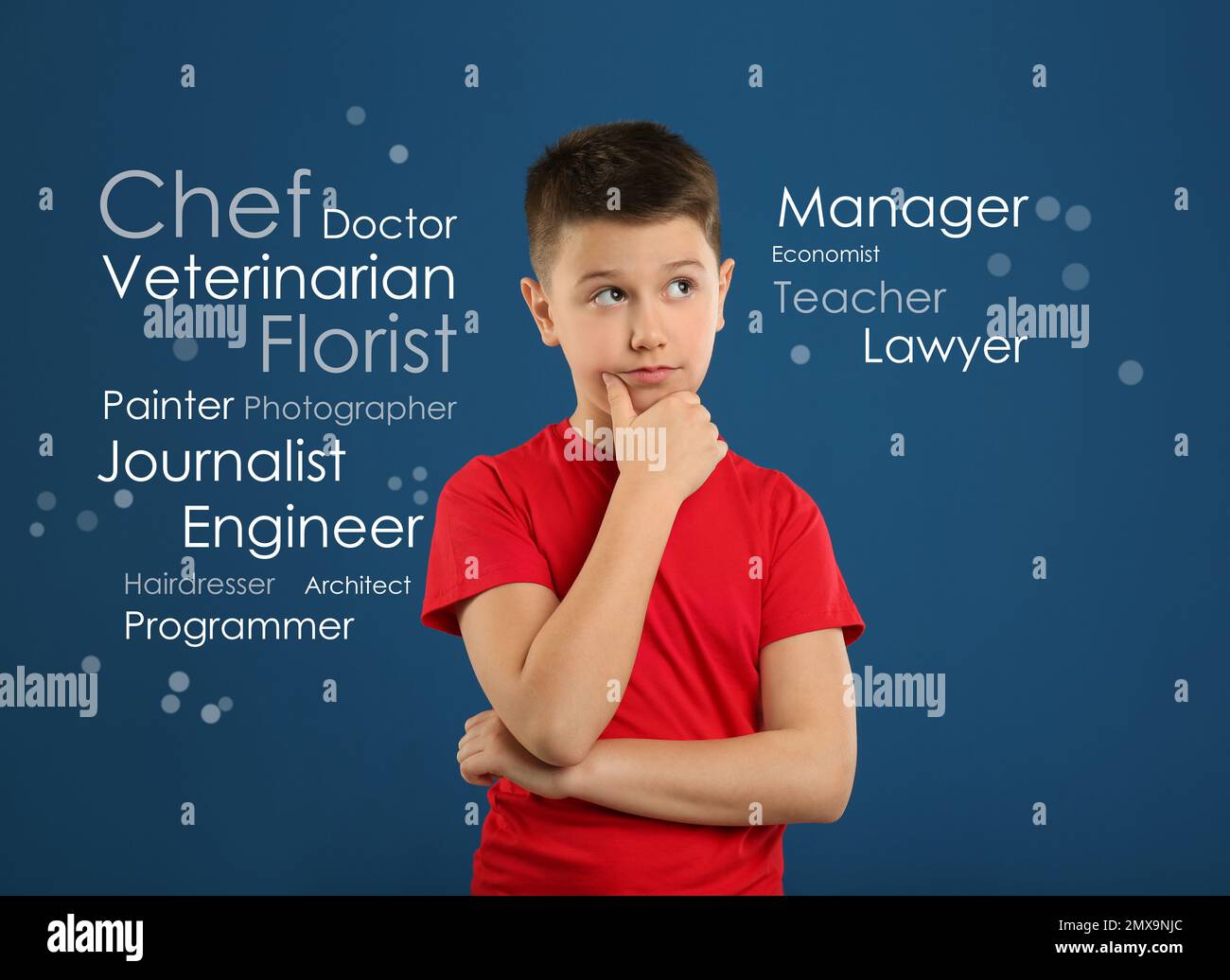 Thoughtful little boy choosing profession on blue background Stock ...
