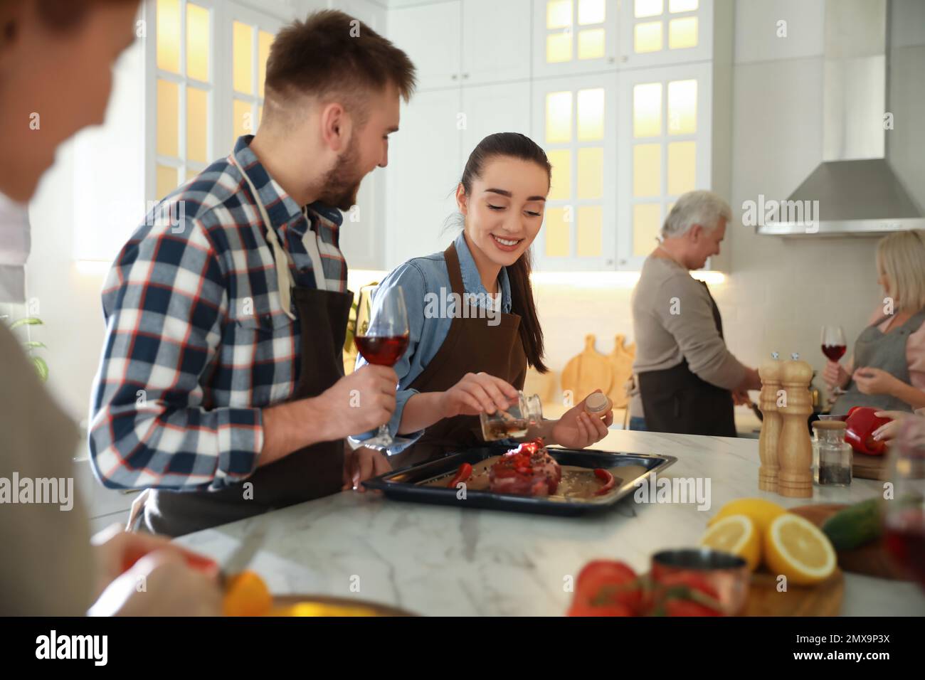 Happy people cooking food together in kitchen Stock Photo - Alamy