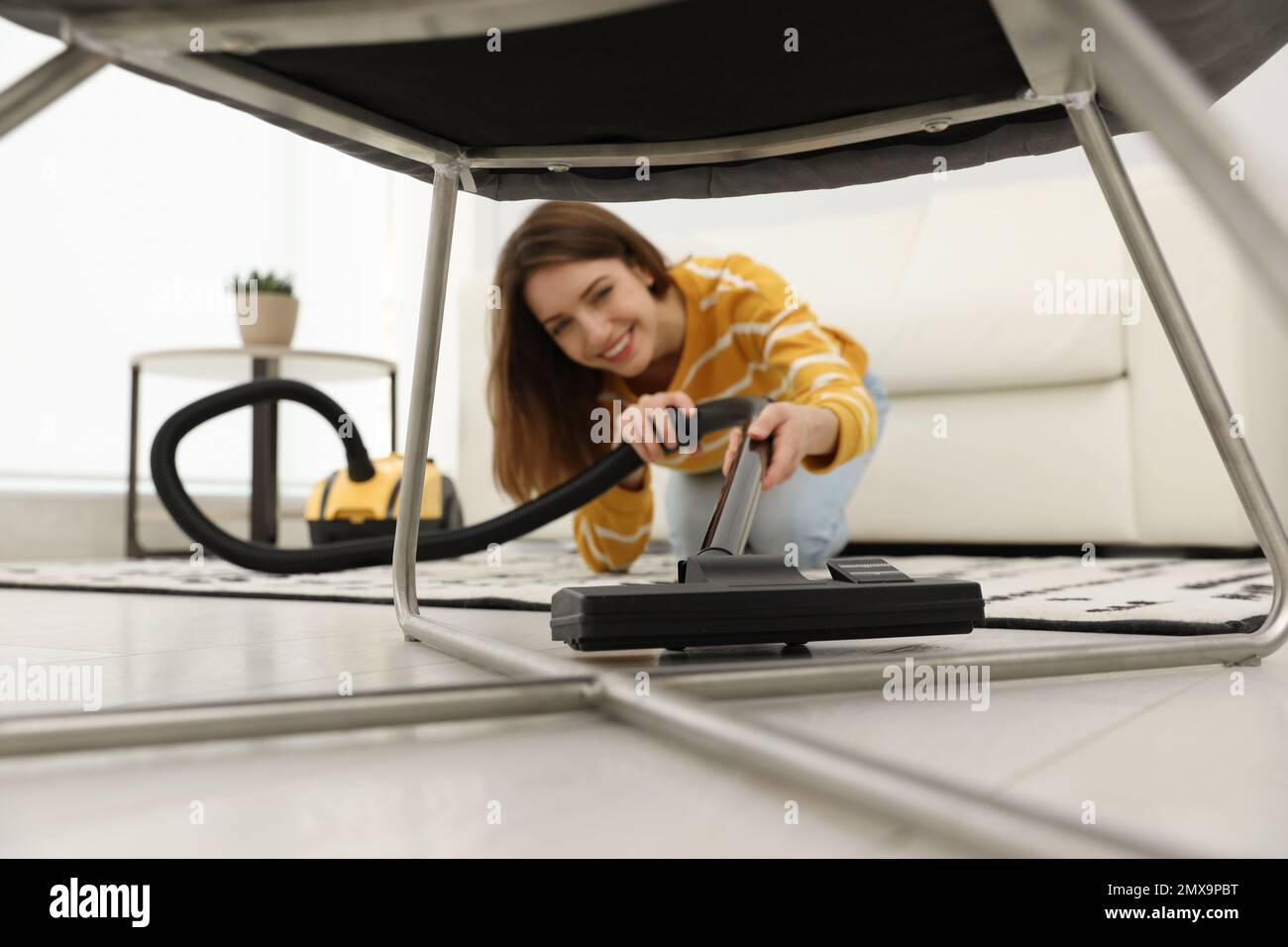 Woman using vacuum cleaner hi-res stock photography and images - Alamy