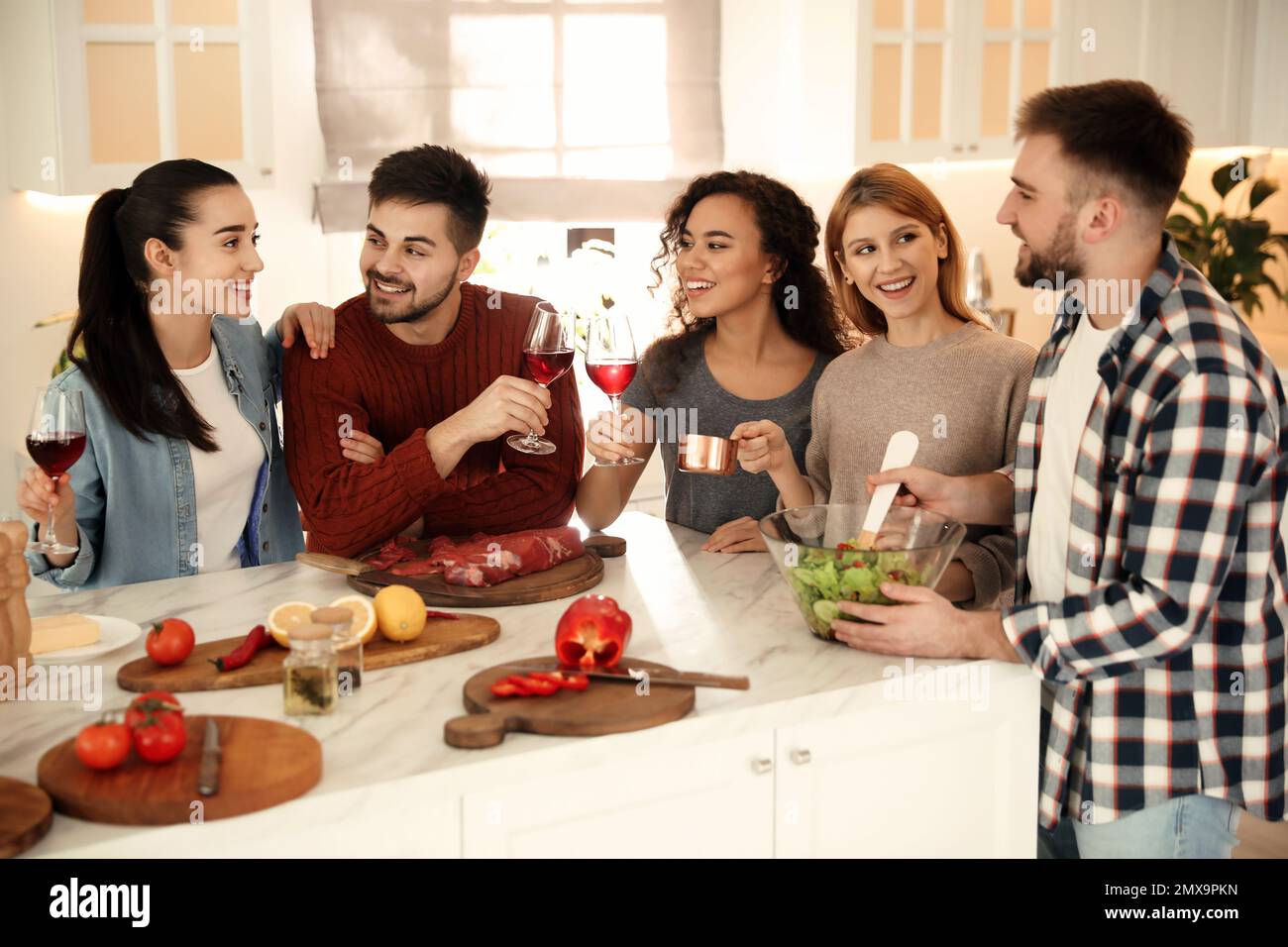 Happy people cooking food together in kitchen Stock Photo - Alamy