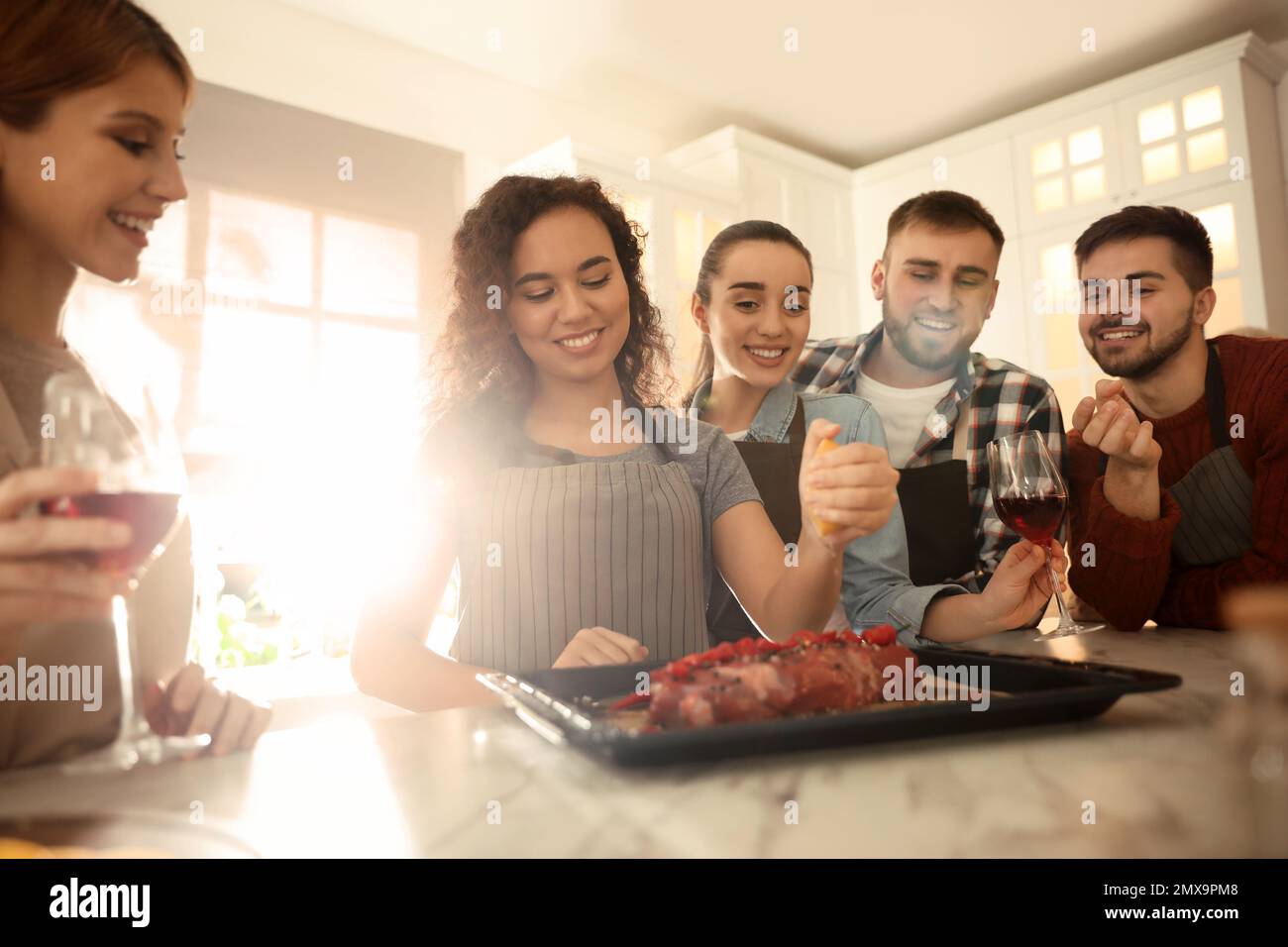 Happy people cooking food together in kitchen Stock Photo - Alamy