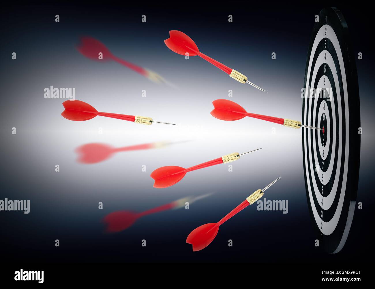 Board and red darts on dark background Stock Photo - Alamy