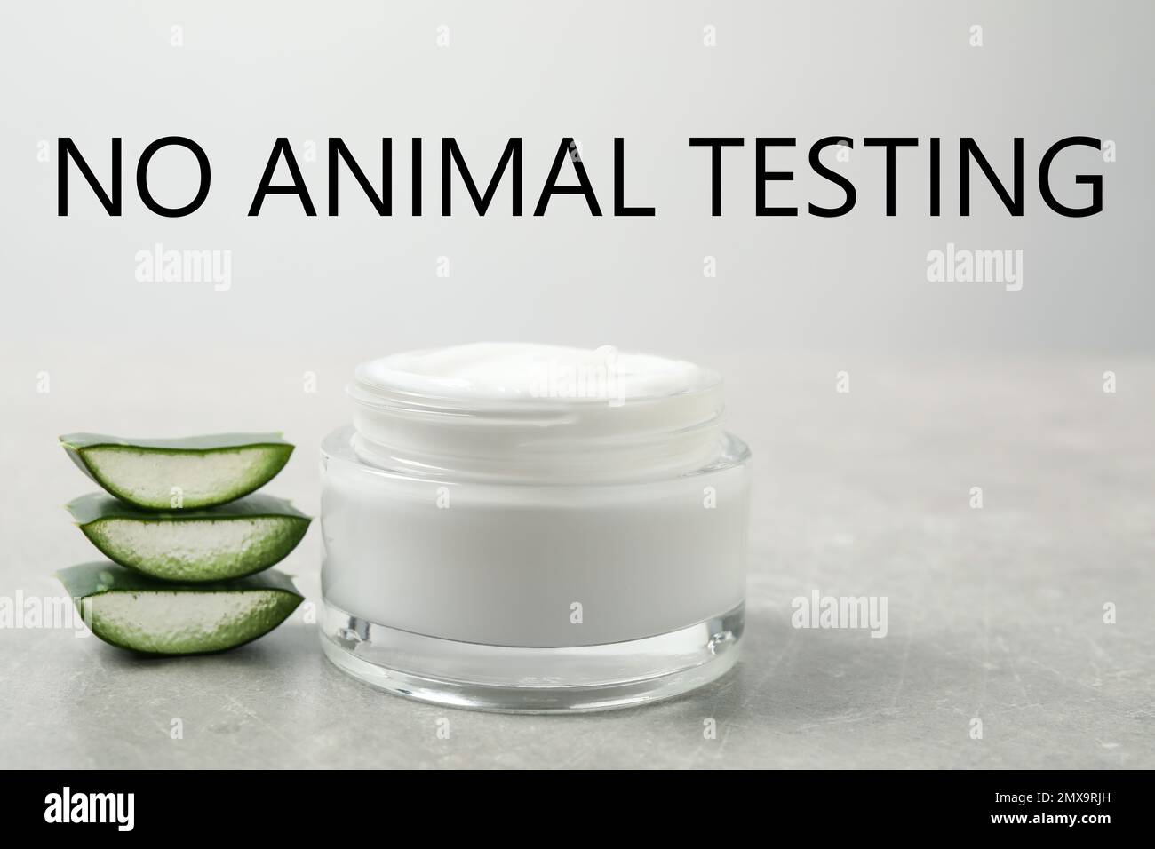Jar of cream, aloe and text NO ANIMAL TESTING on light background Stock ...