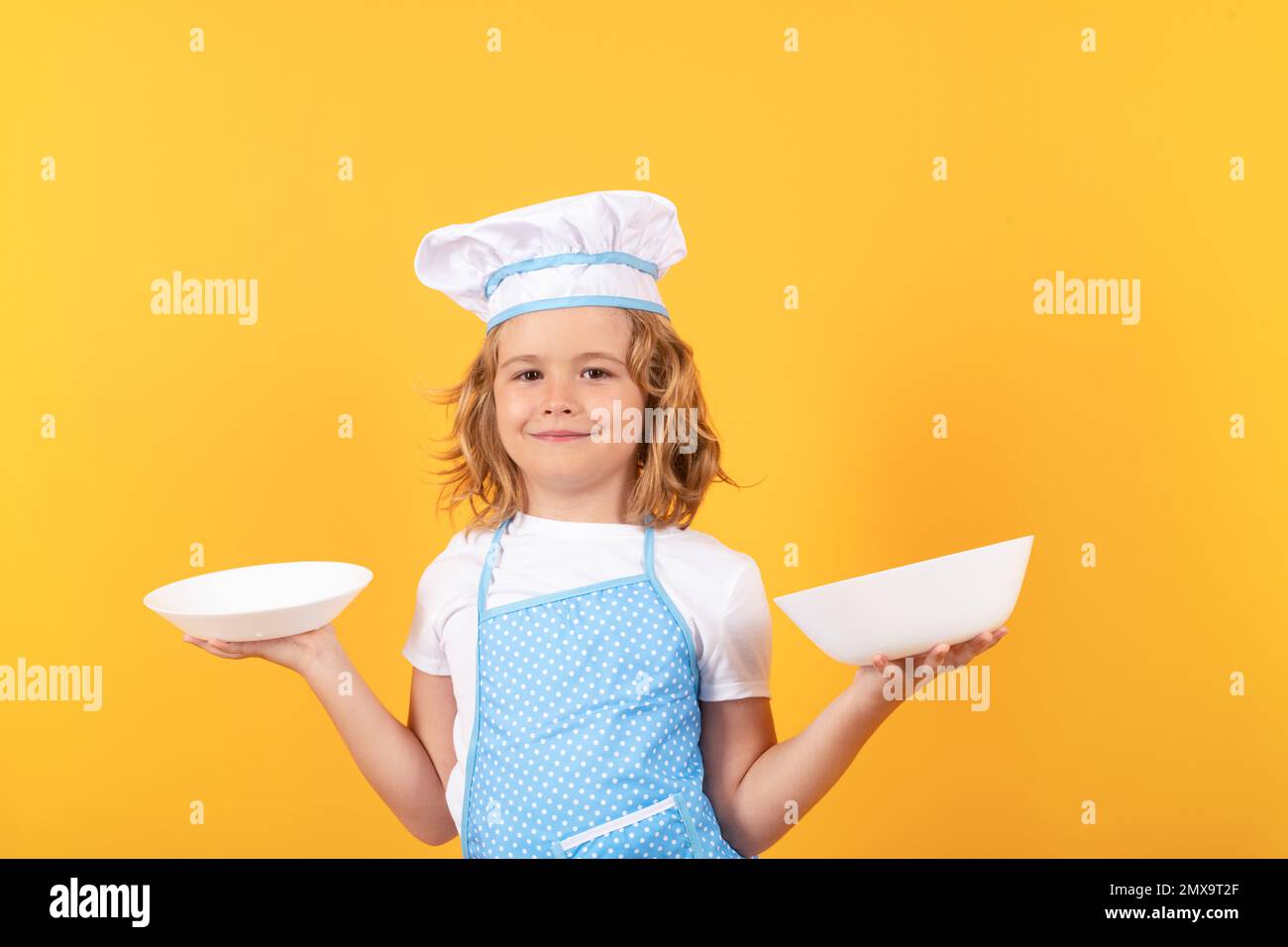 Funny kid chef cook with kitchen plate, studio portrait. Chef kid boy ...