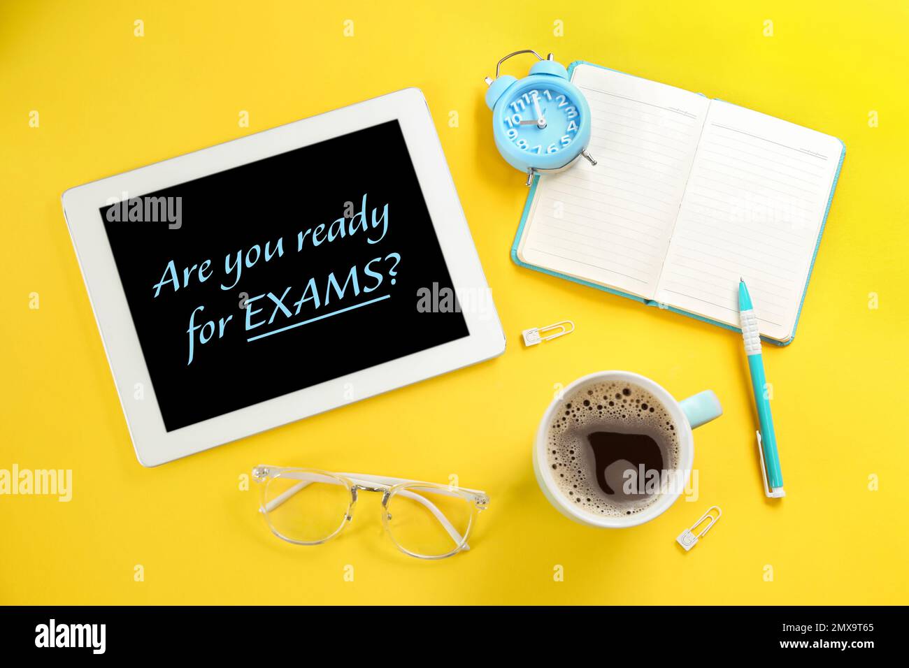 Modern tablet with phrase ARE YOU READY FOR EXAMS on yellow background ...