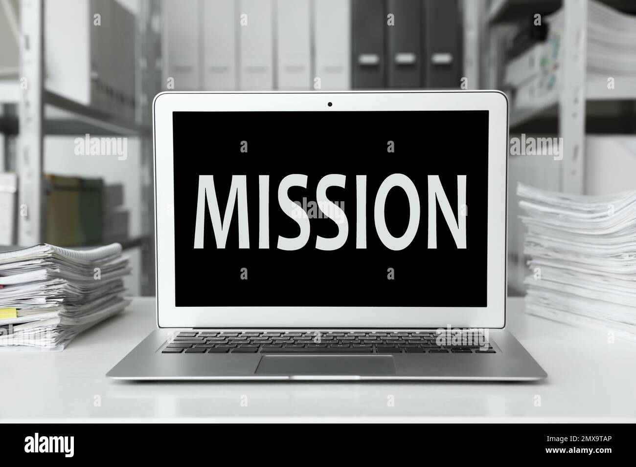 Modern laptop with word MISSION on screen indoors Stock Photo - Alamy