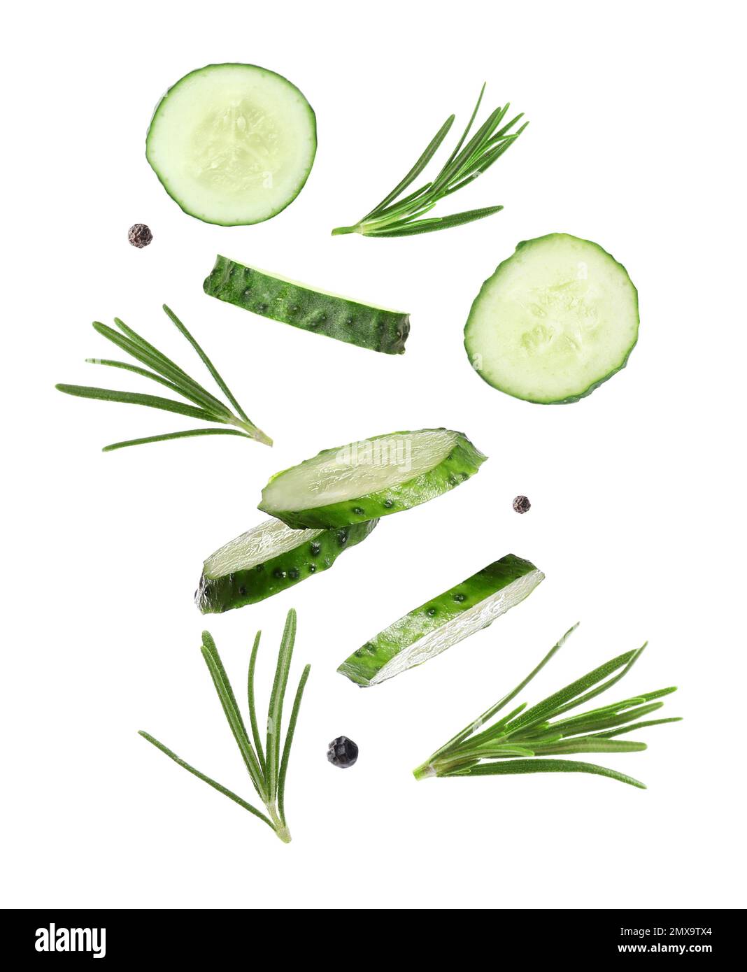 Set of flying fresh cucumber slices and other ingredients on white ...