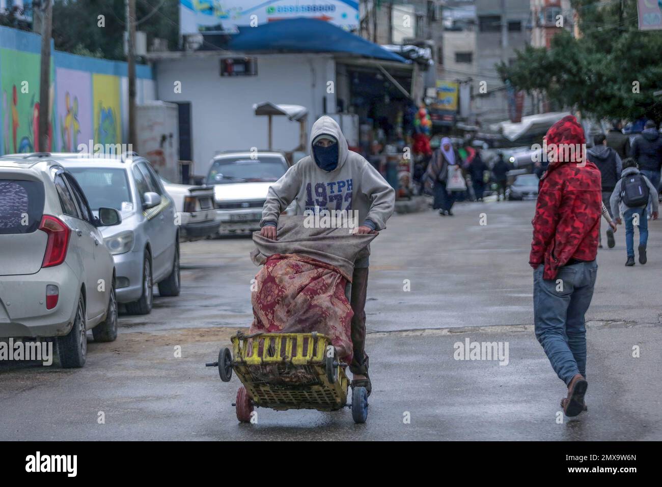 Gaza, Palestine. 1st Feb, 2023. Palestinian worker pushes a cart in the ...