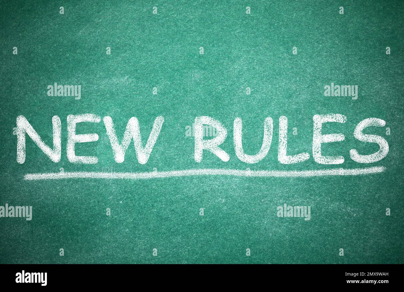 Text NEW RULES written on green board Stock Photo - Alamy