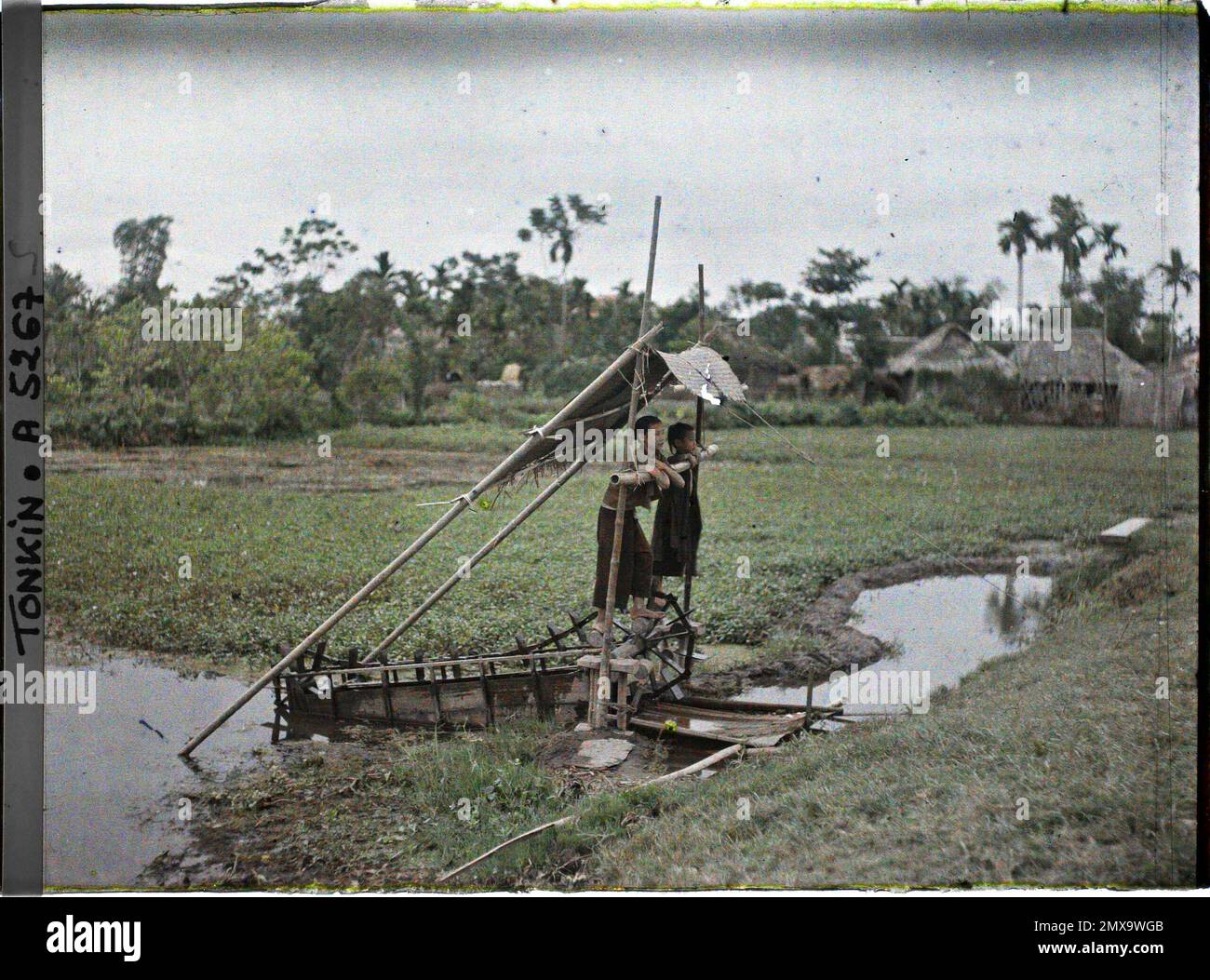 Tonkin, Indochina of children using a machine on foot, a lifting system ...