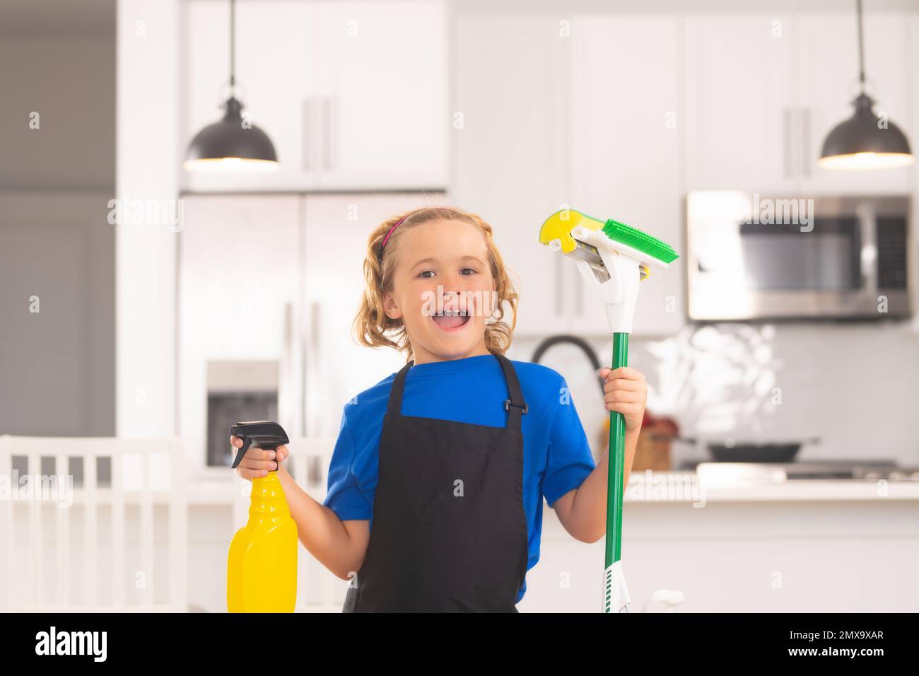 Portrait of child helping with housework, cleaning the house ...