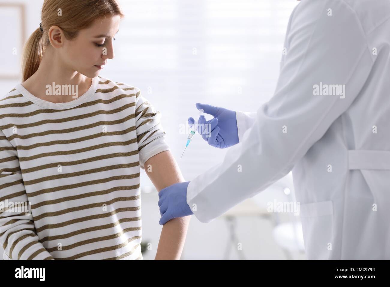 Doctor giving injection to patient in hospital. Vaccination concept ...