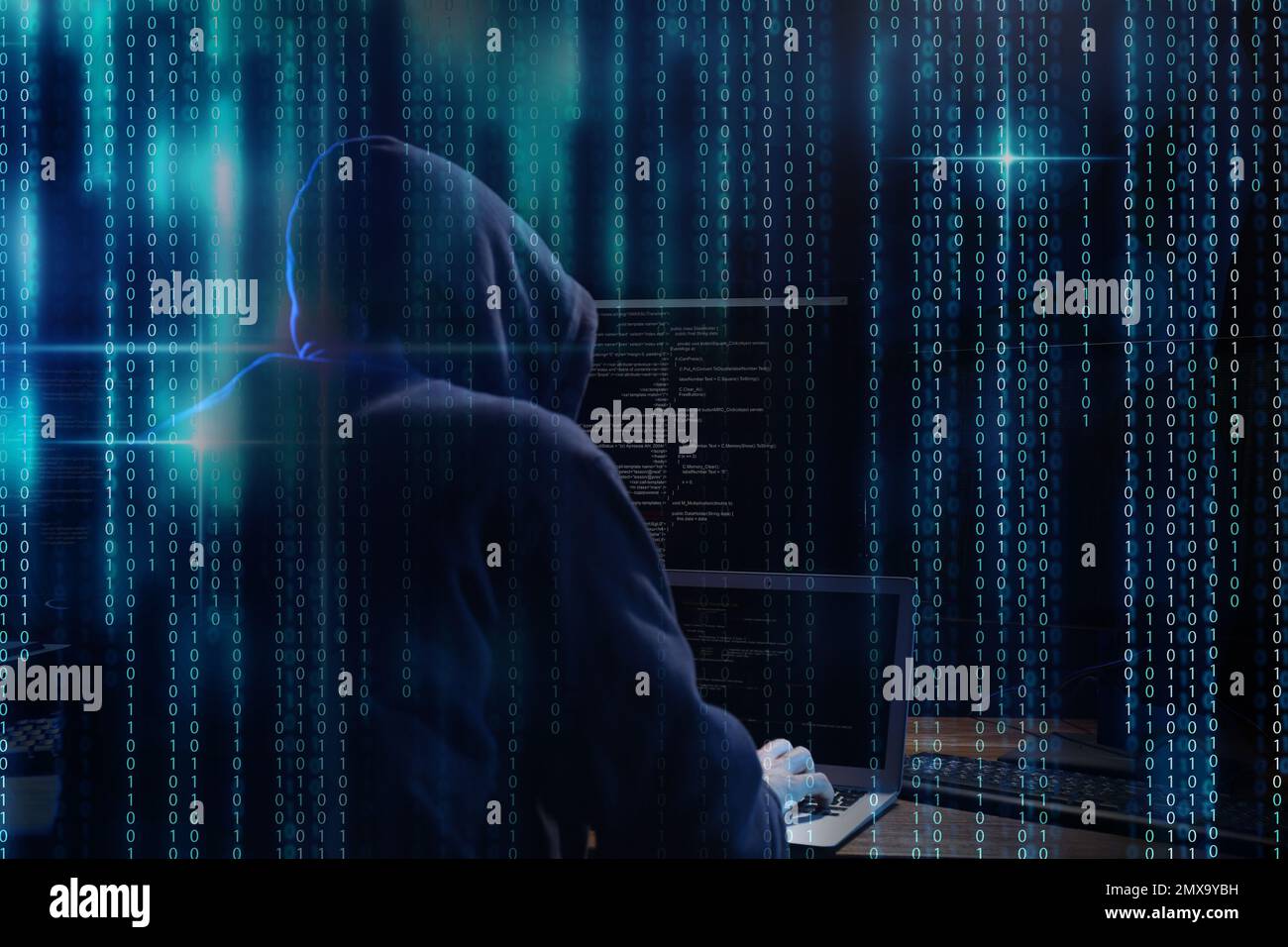 Cyber criminal hacking system at table, digital binary code on ...