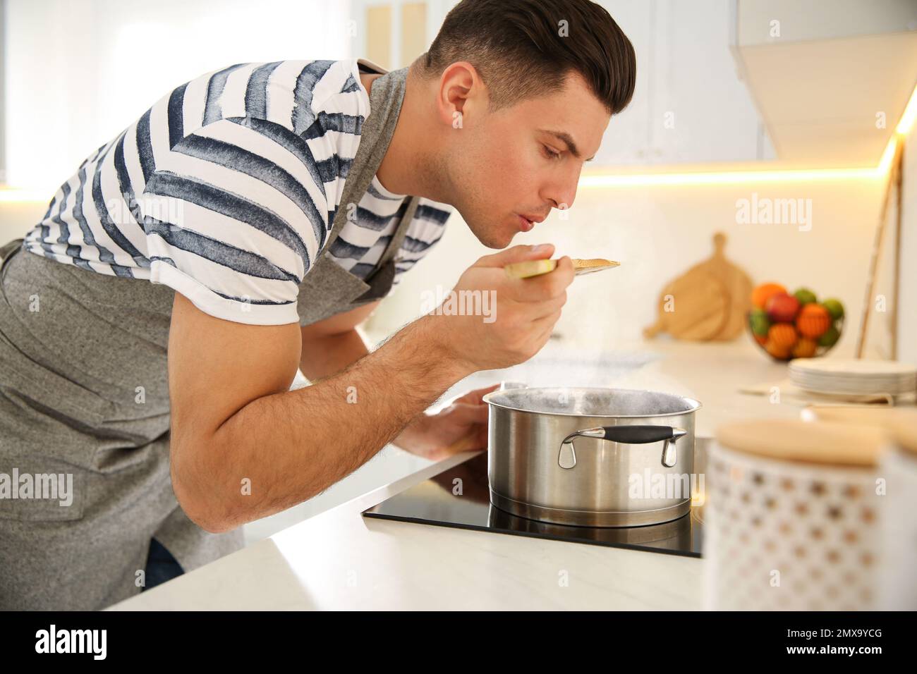 Man cooking at stove hi-res stock photography and images - Alamy