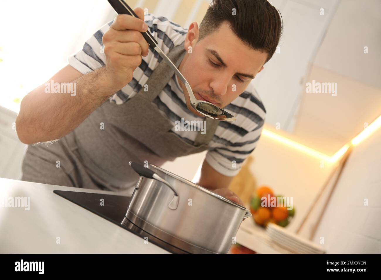 Man cooking at stove hi-res stock photography and images - Alamy