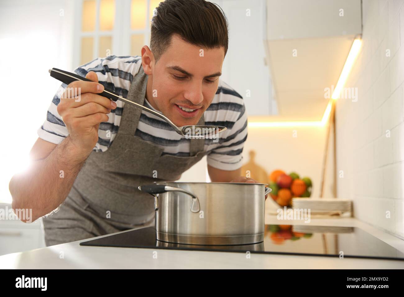 Man cooking at stove hi-res stock photography and images - Alamy