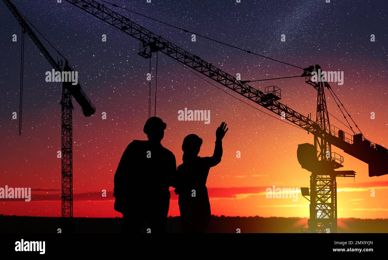 Silhouettes of engineers near construction site at sunrise Stock Photo ...