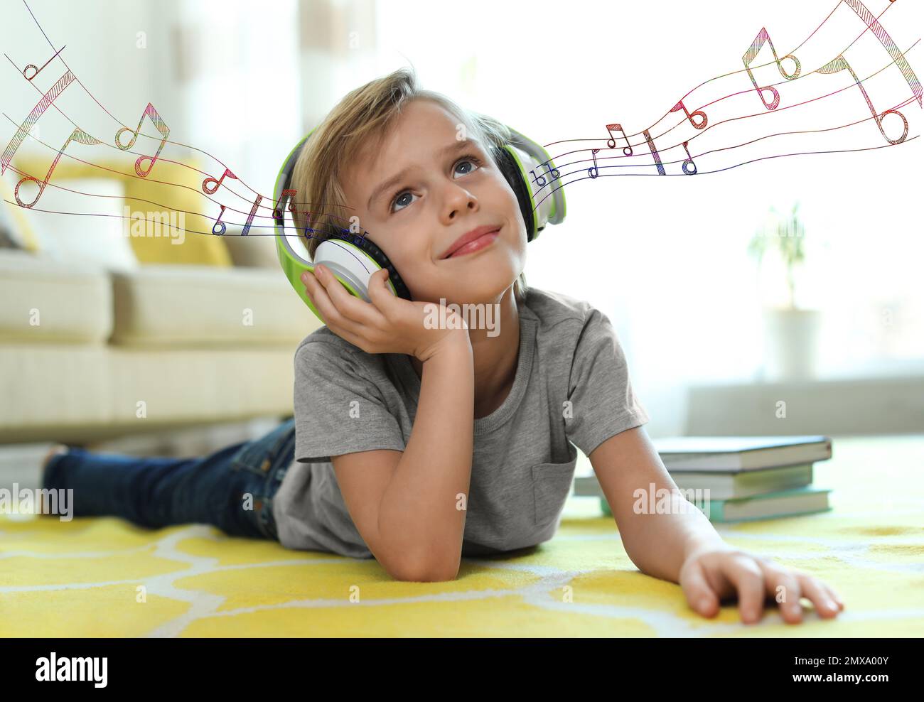 Cute little boy listening to music with headphones at home. Bright ...