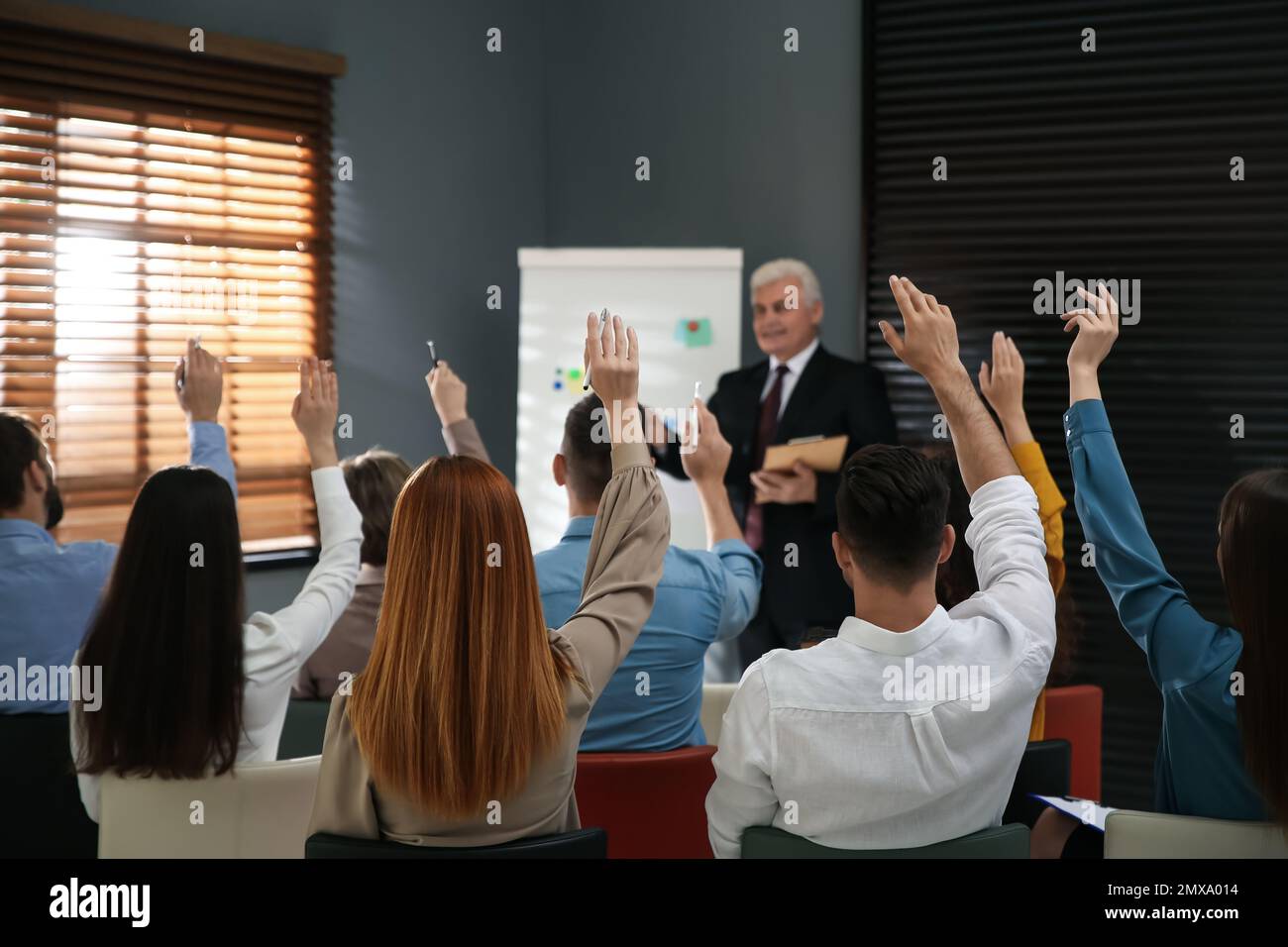 People raising hands to ask questions at seminar in office Stock Photo ...