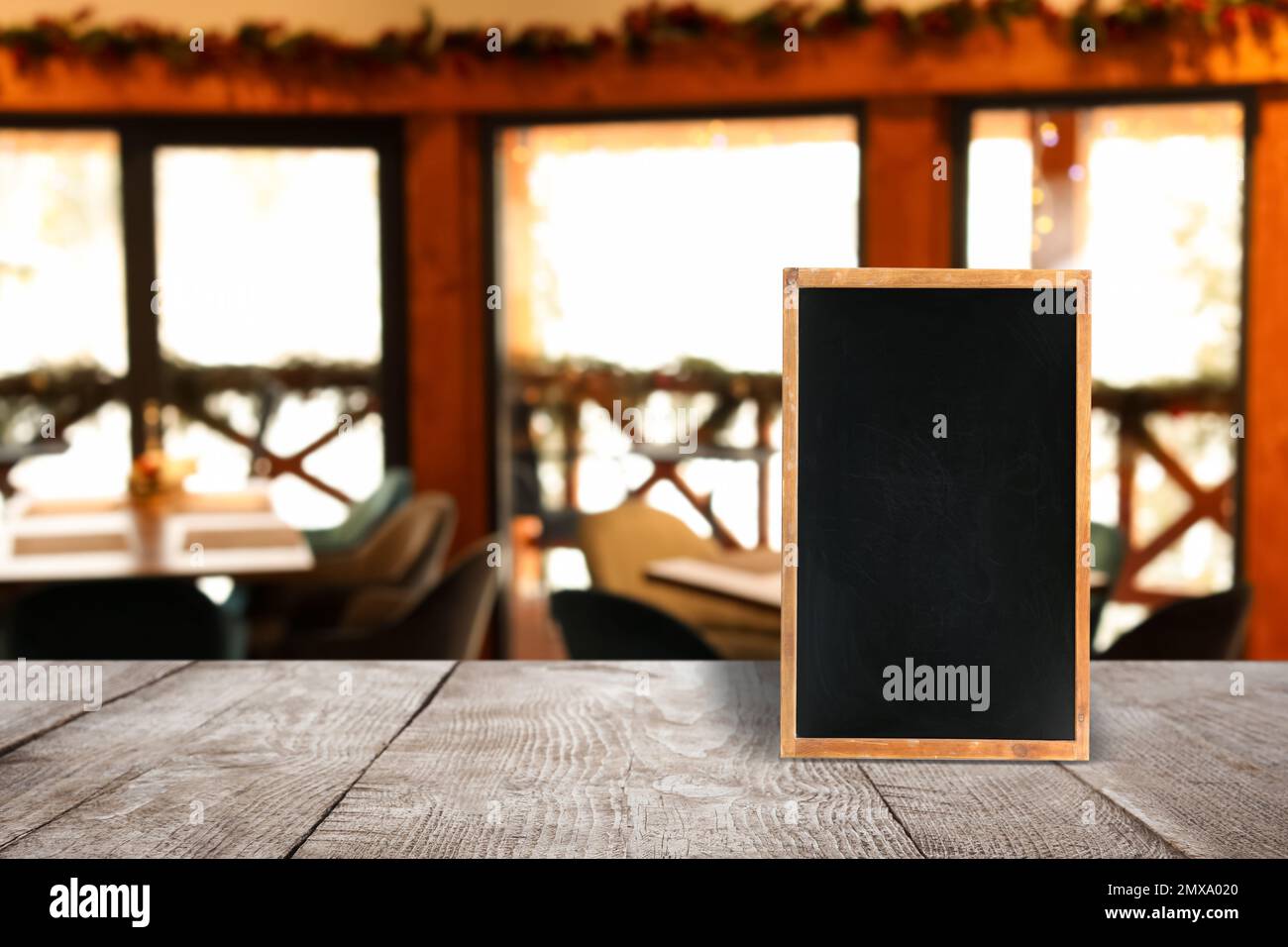 Blank small blackboard on wooden table in cafe, mockup for menu design ...