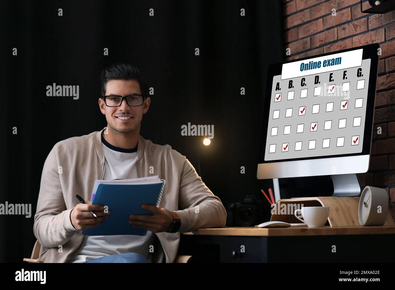 Student with notebook at workplace at home. Online exam Stock Photo - Alamy