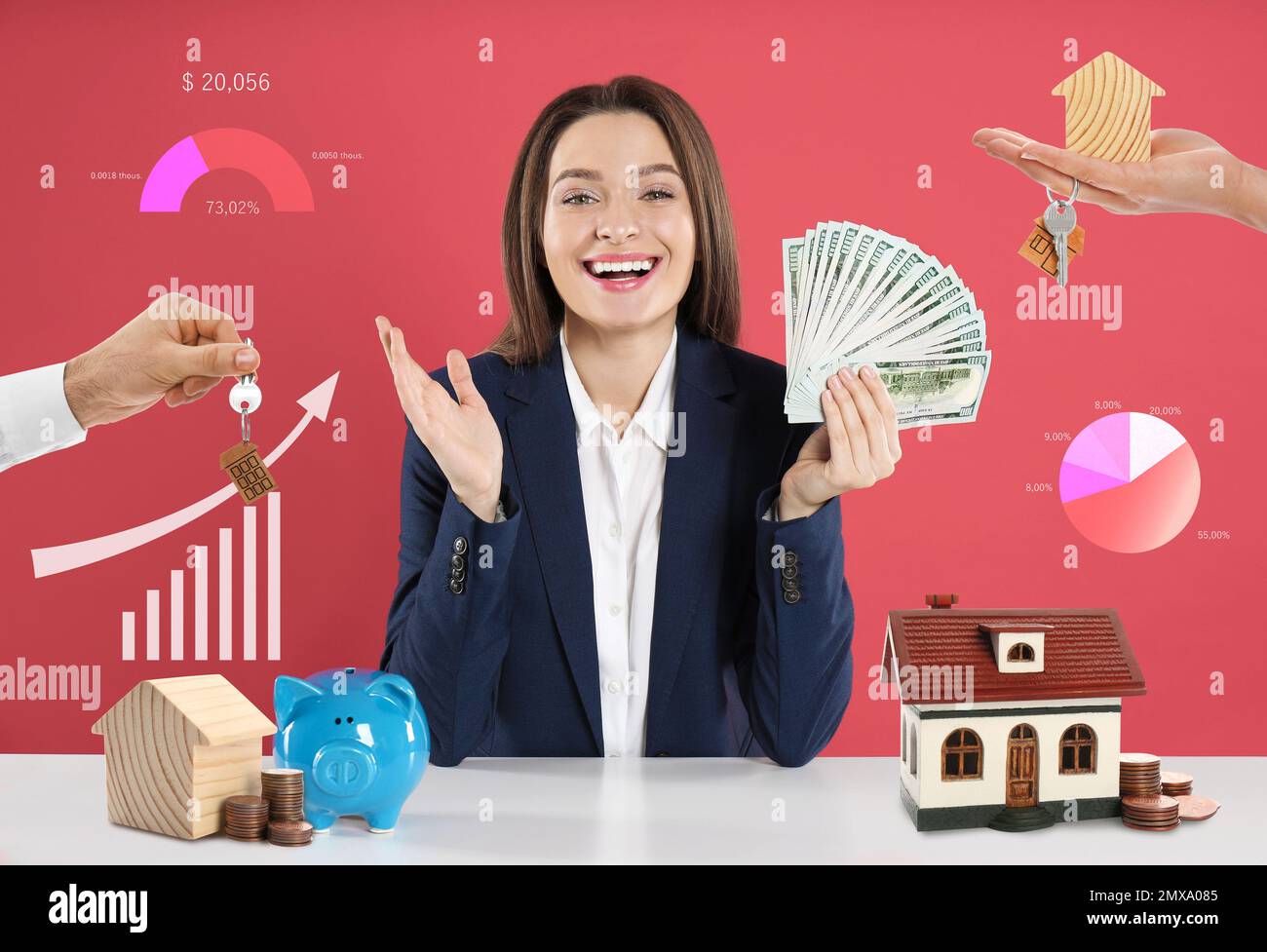 Excited woman with money and house models at table against pink ...