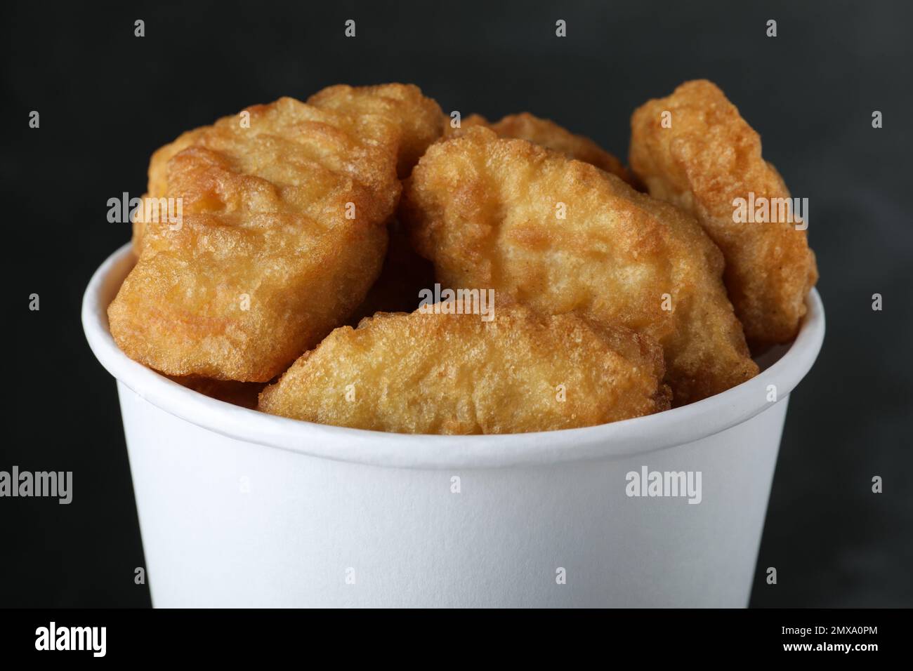Bucket with delicious chicken nuggets on grey background, closeup Stock ...