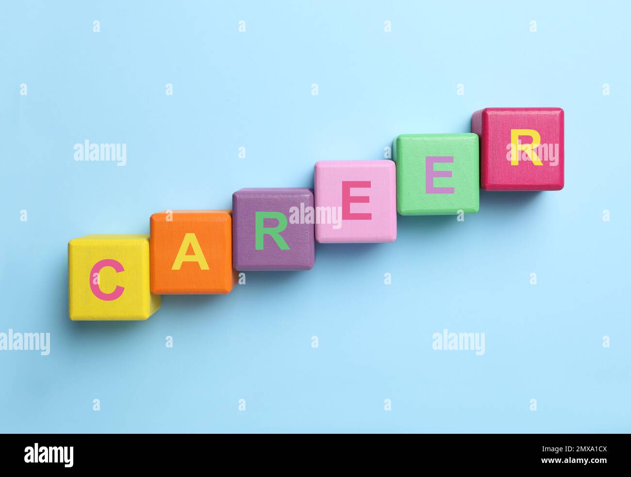 Colorful cubes with word CAREER on light blue background, flat lay ...