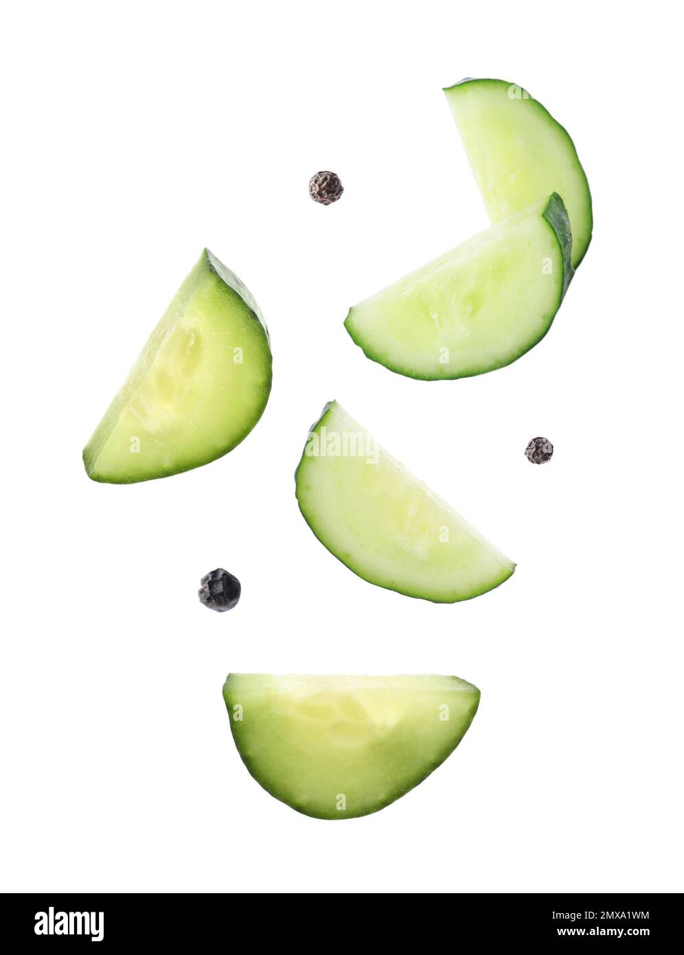 Set of flying cucumber slices and peppercorns on white background Stock ...