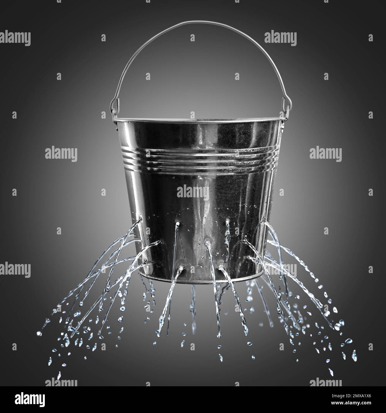Leaky bucket with water on dark background Stock Photo - Alamy