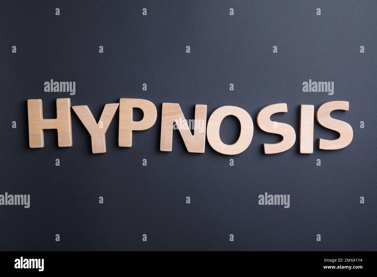 Word HYPNOSIS made with wooden letters on black background, flat lay ...