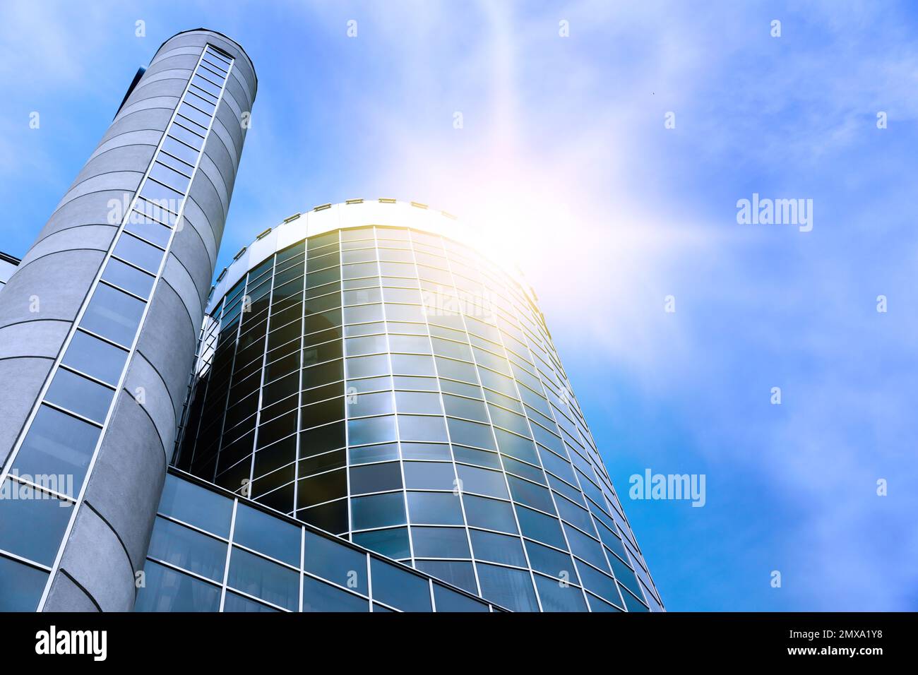 Modern skyscraper with tinted windows against blue sky, low angle view ...