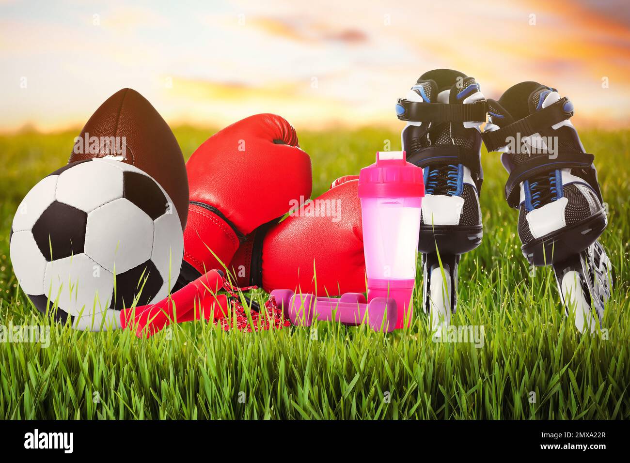 Set of different sport equipment on green grass Stock Photo - Alamy
