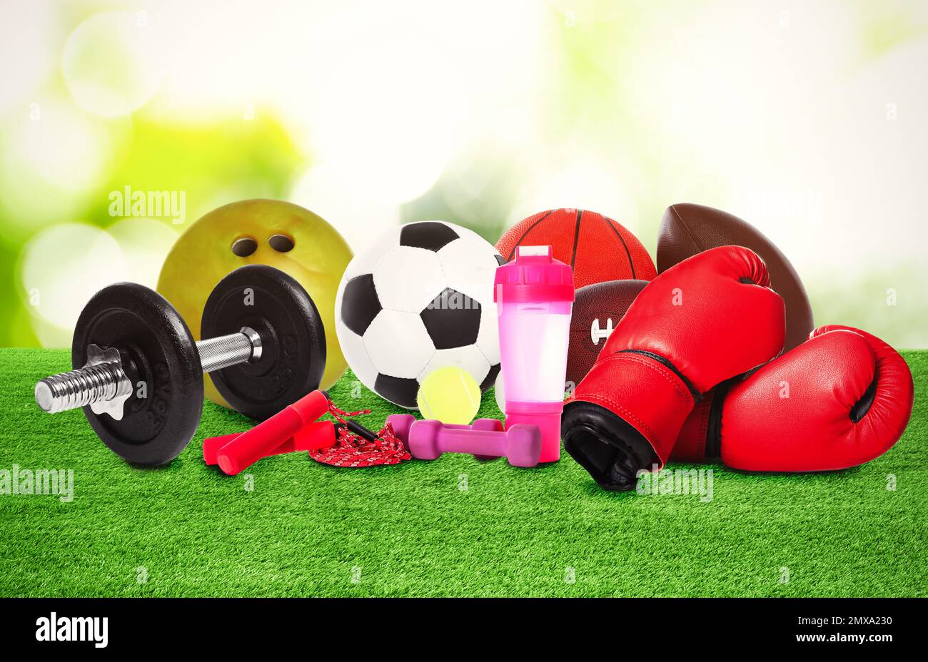 Set of different sport equipment on green grass Stock Photo - Alamy