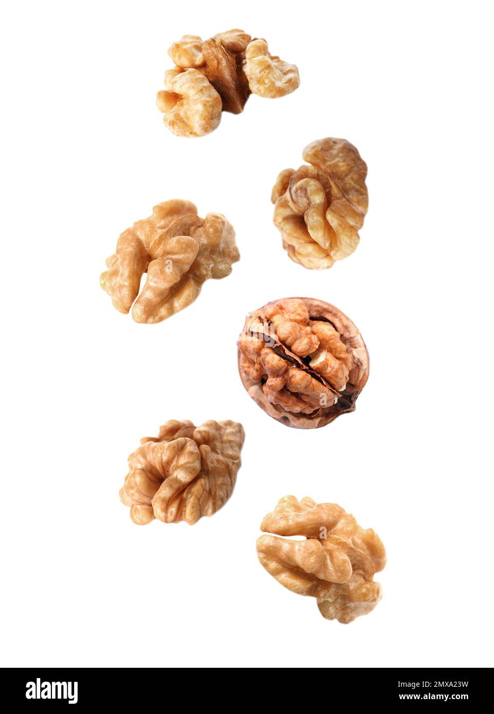 Tasty walnuts falling on white background Stock Photo - Alamy