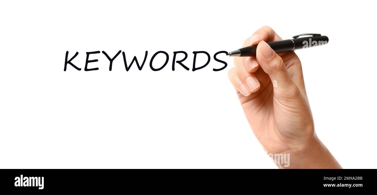 Woman writing word KEYWORDS on transparent board against white ...