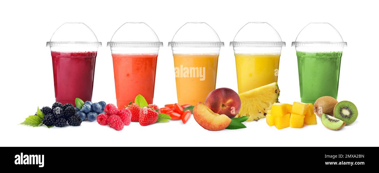 Different delicious smoothies in plastic cups on white background ...