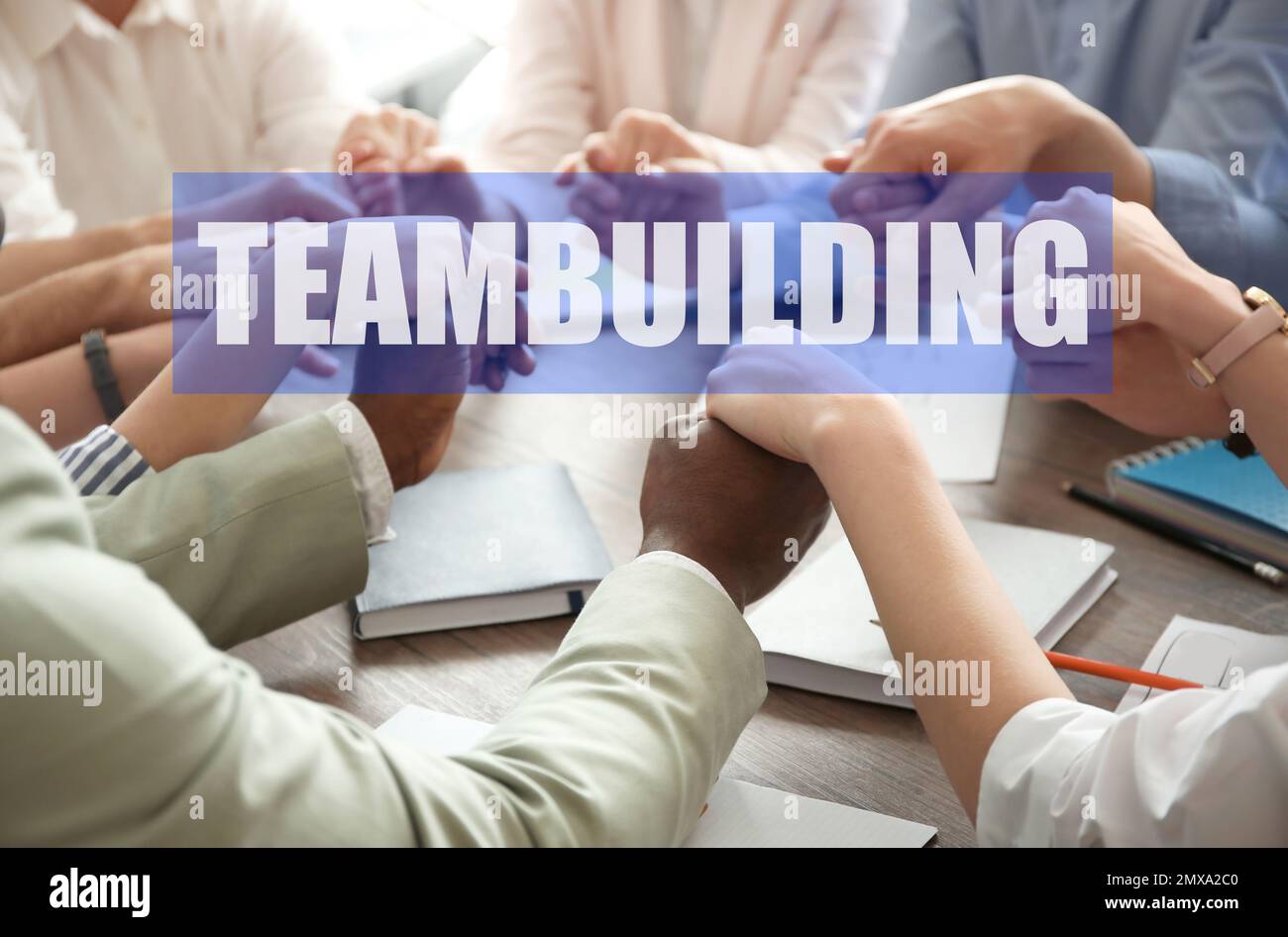 Core values concept. People holding hands together at table, closeup ...