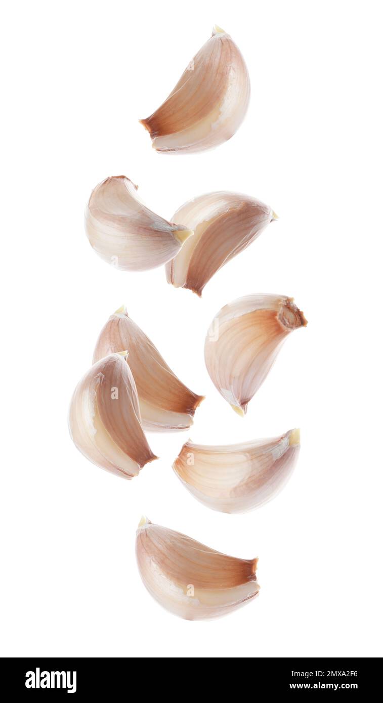 Set of falling garlic cloves on white background Stock Photo - Alamy