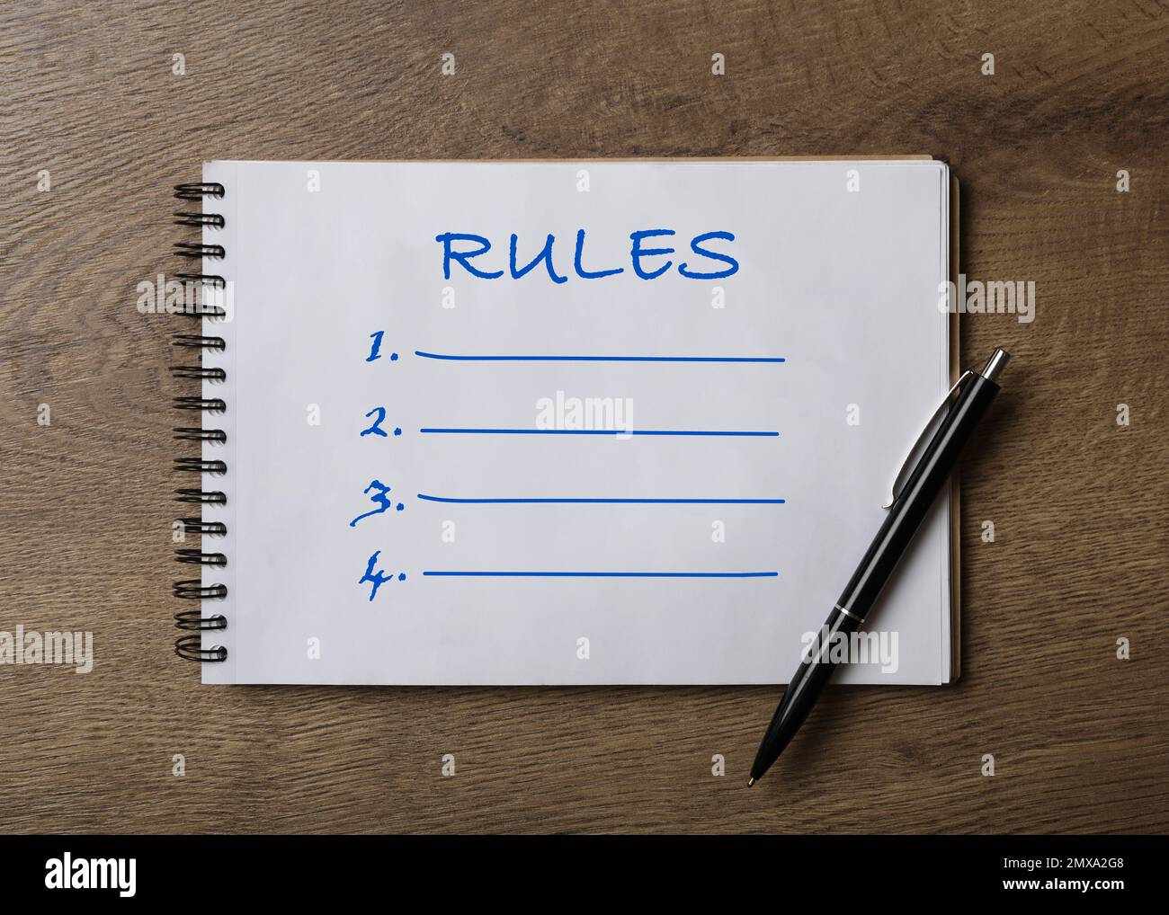 Notebook with list of rules and pen on wooden table, top view Stock ...