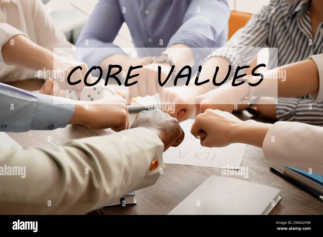 Core values concept. People putting hands together at table, closeup ...
