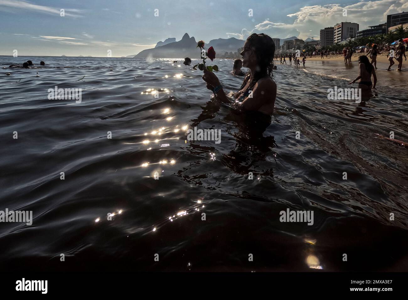 Devotees of the sea goddess Yemanja place flower offerings for her in ...