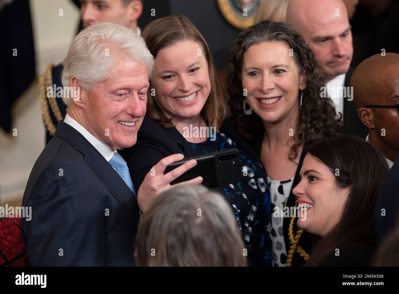 Former United States President Bill Clinton poses for photos with ...